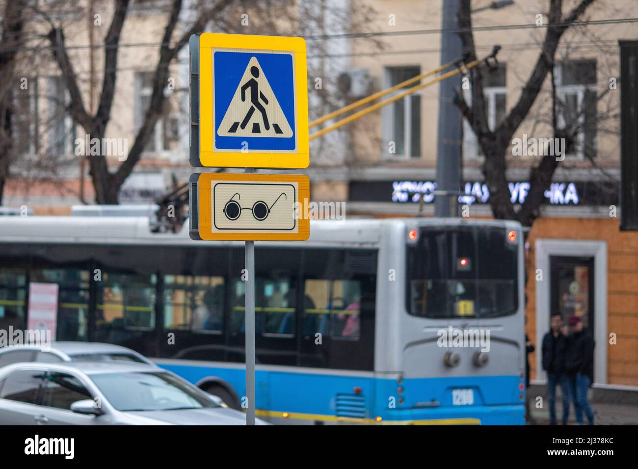 Pedestrian crossing sign for the blind on a busy Almaty street. Almaty ...