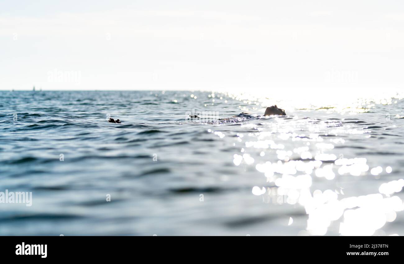 Floating in the ocean Stock Photo - Alamy