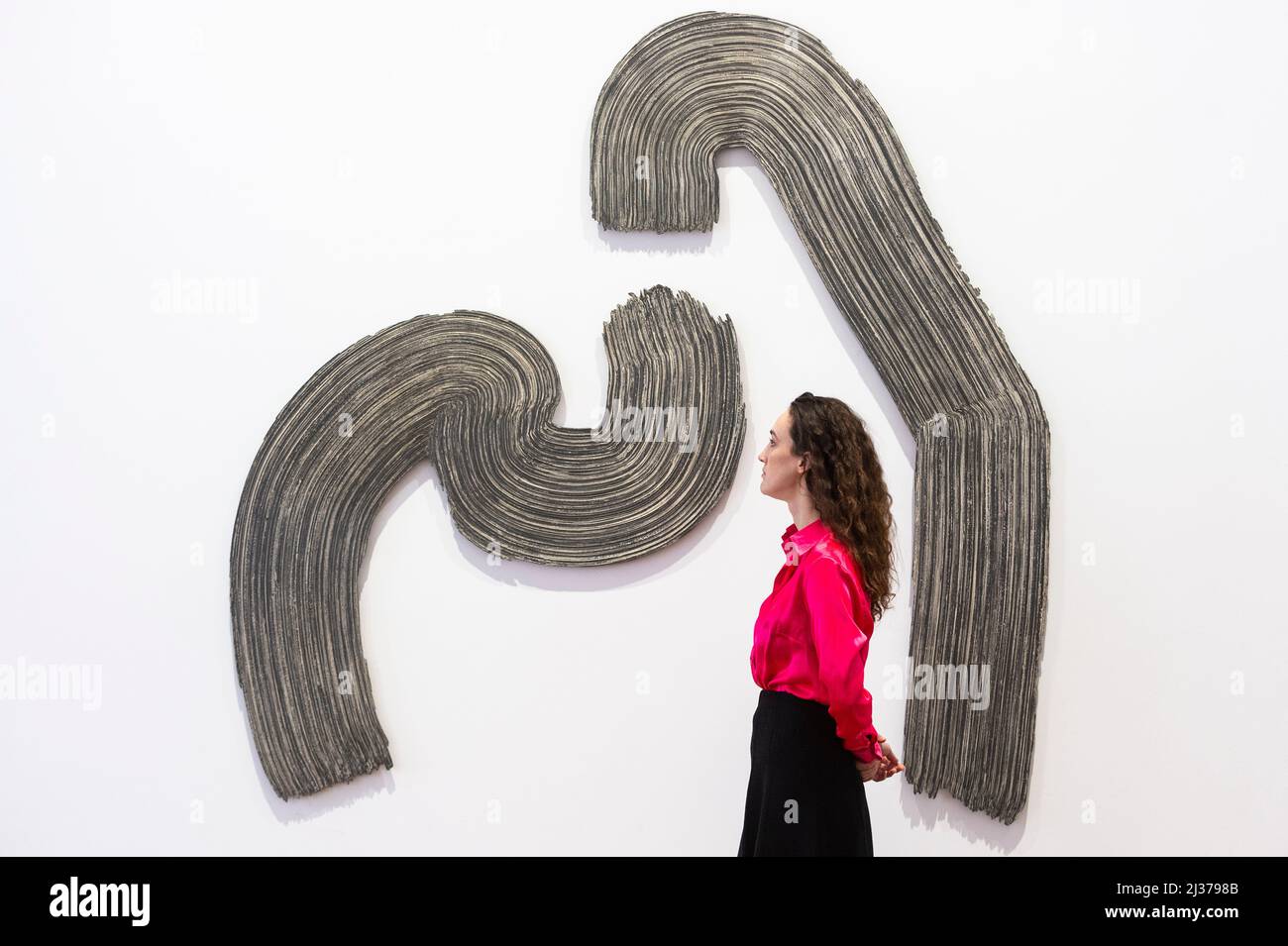 London, UK. 6 April 2022. A staff member poses with "Pray Do", 2003, by ...