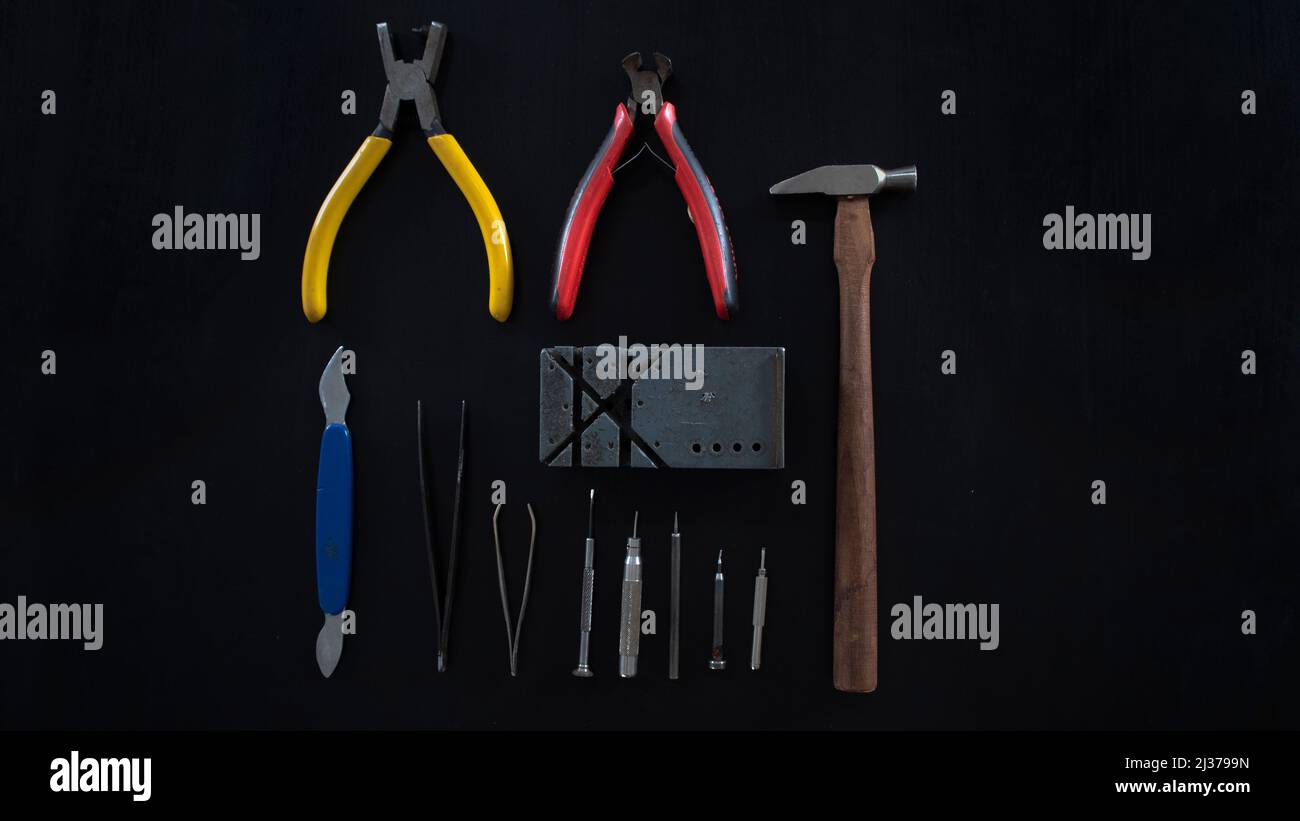 Several watch repair tools, isolated on black background, hardware for ...