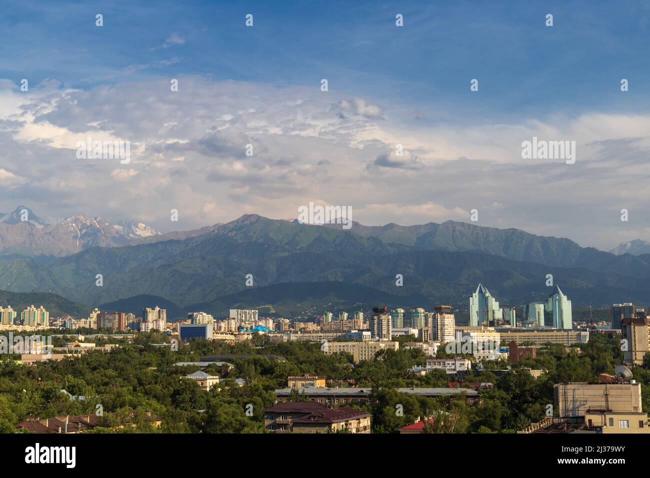 Aerial view of the city of Almaty immersed in greenery at the foot of ...