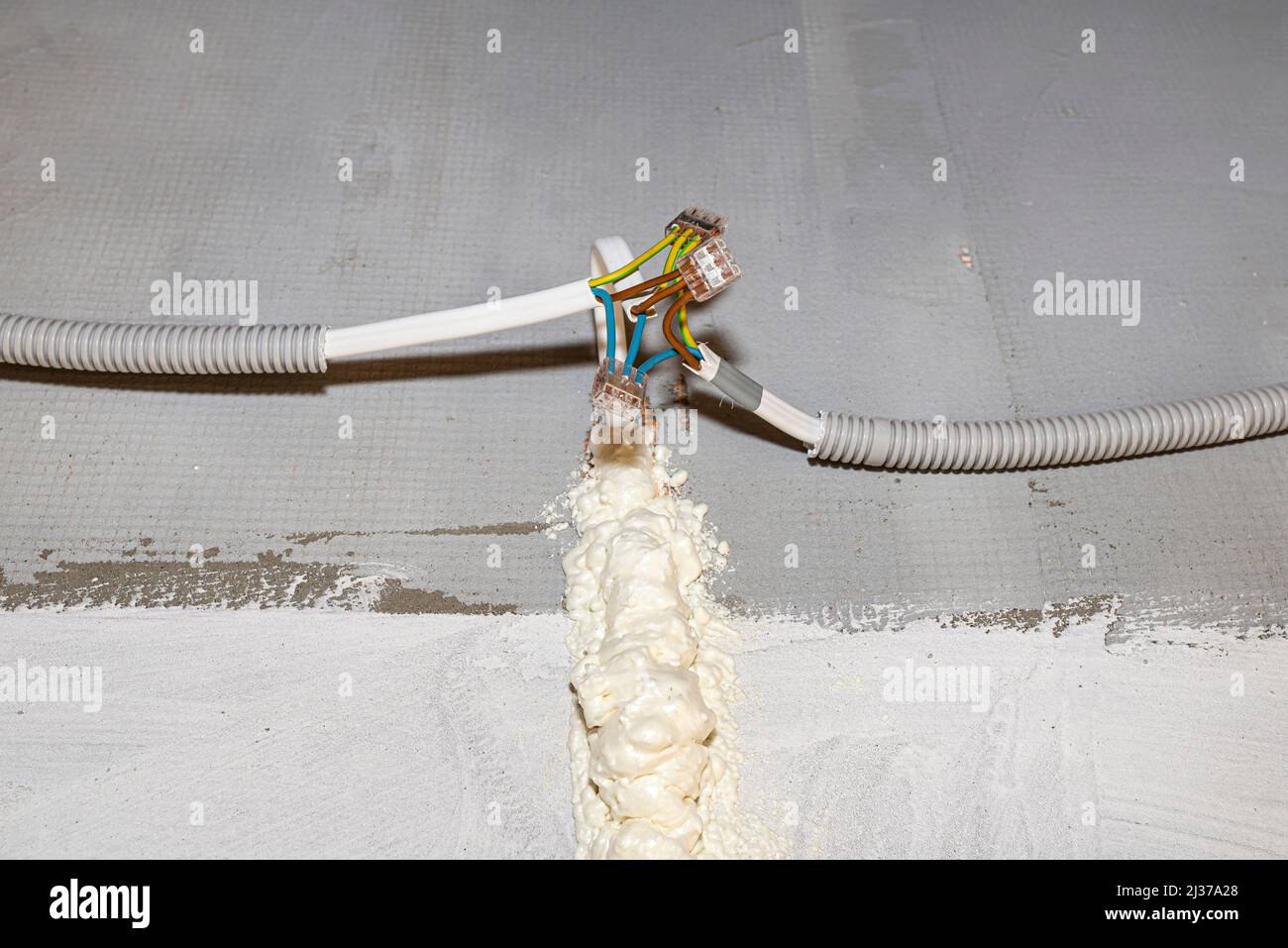 Cable groove filled with mounting foam in the facade of a polystyrene ...