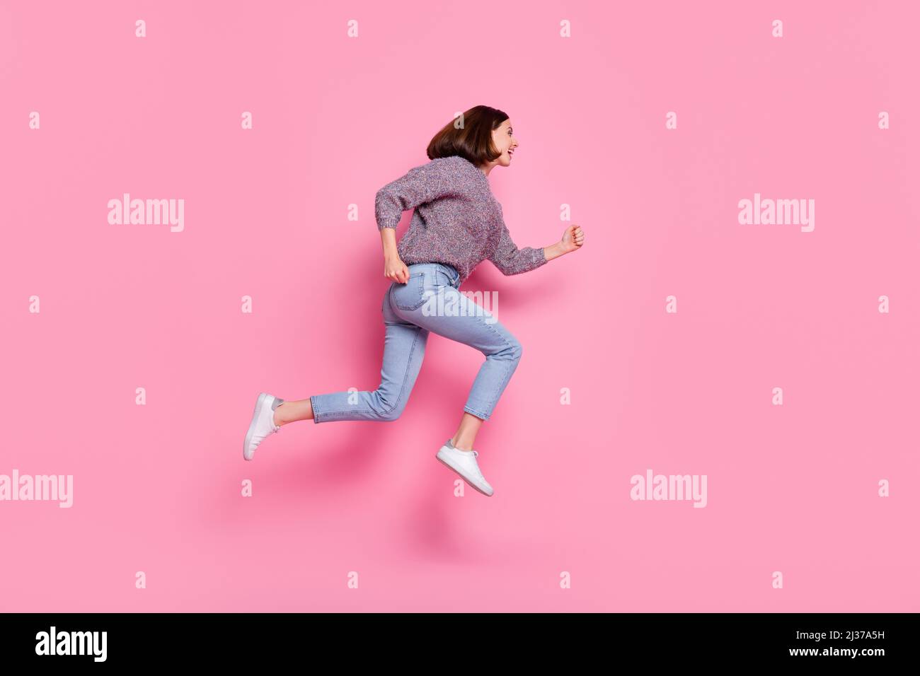 Full length body size view of attractive cheerful girl jumping running ...