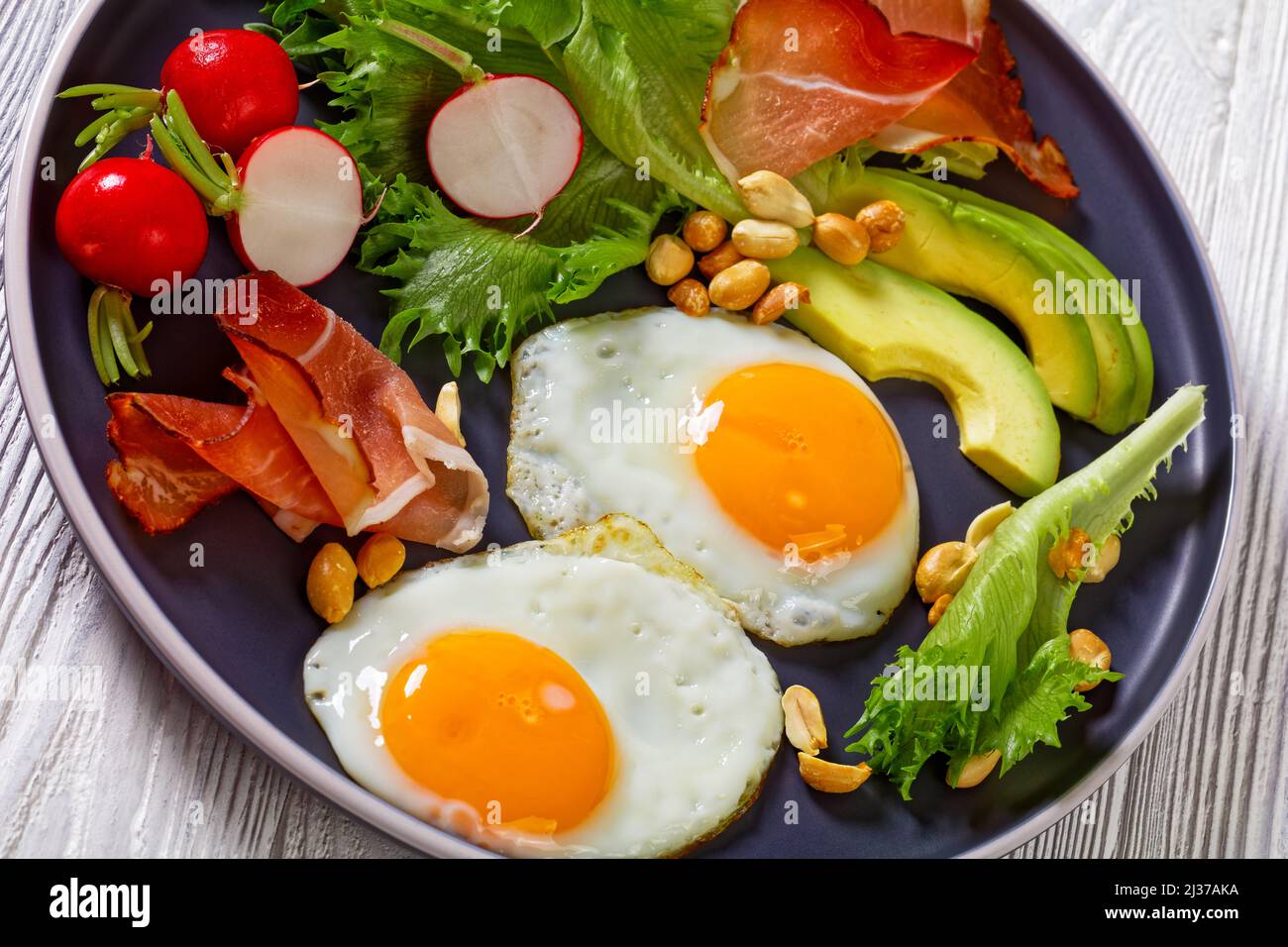 fried eggs, fresh crispy lettuce, avocado slices, red radishes, roasted ...