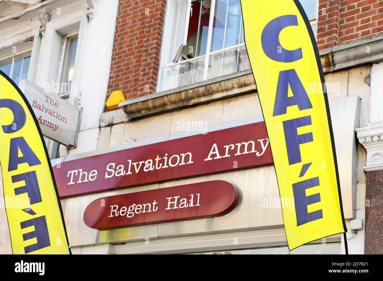 Close up of signs & café advertising above public entrance to Salvation ...