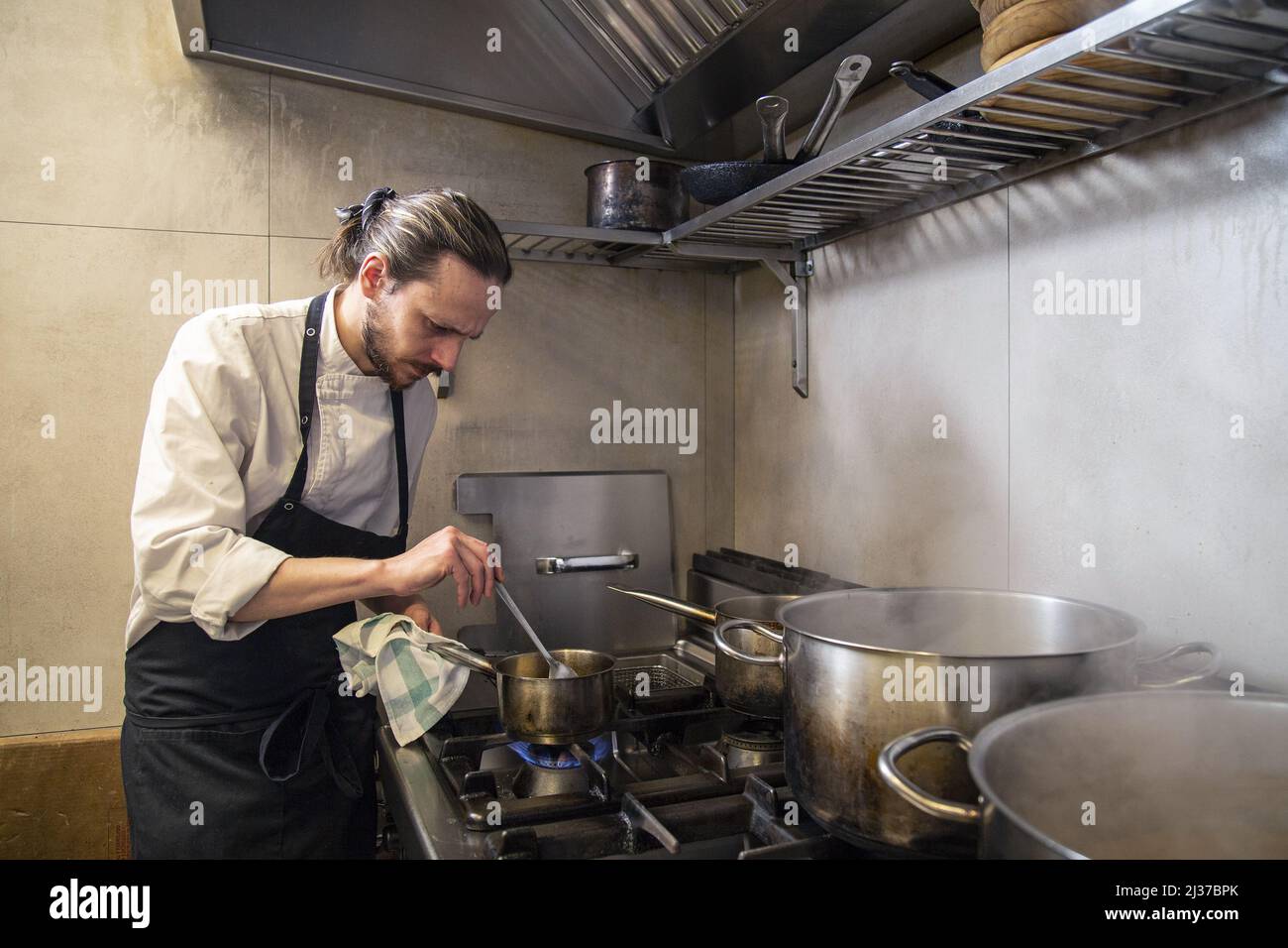 A professional Caucasian chef cooking Italian tortellini pasta on the ...