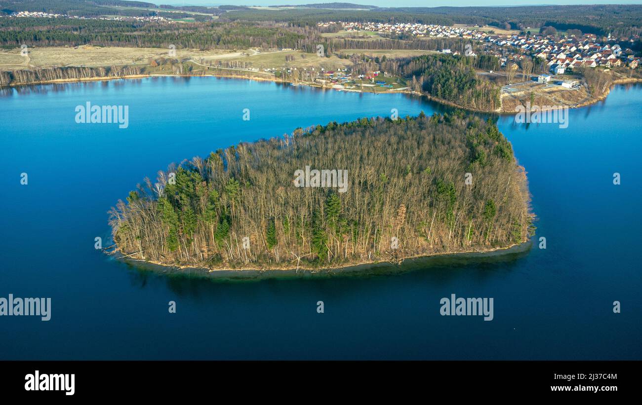 The beautiful view of Steinberger See with green trees on the shore ...