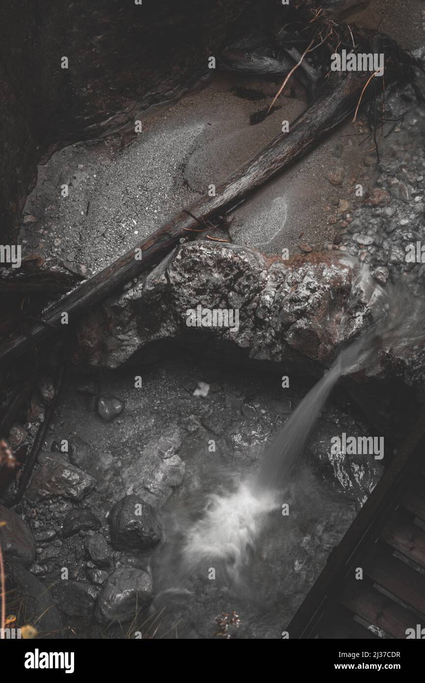 A top view of a waterfall between rocks in the mountain during daytime ...