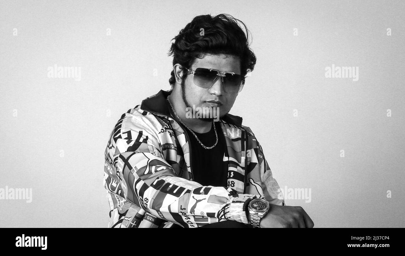 A grayscale portrait of an Indian man in a fashionable jacket posing ...