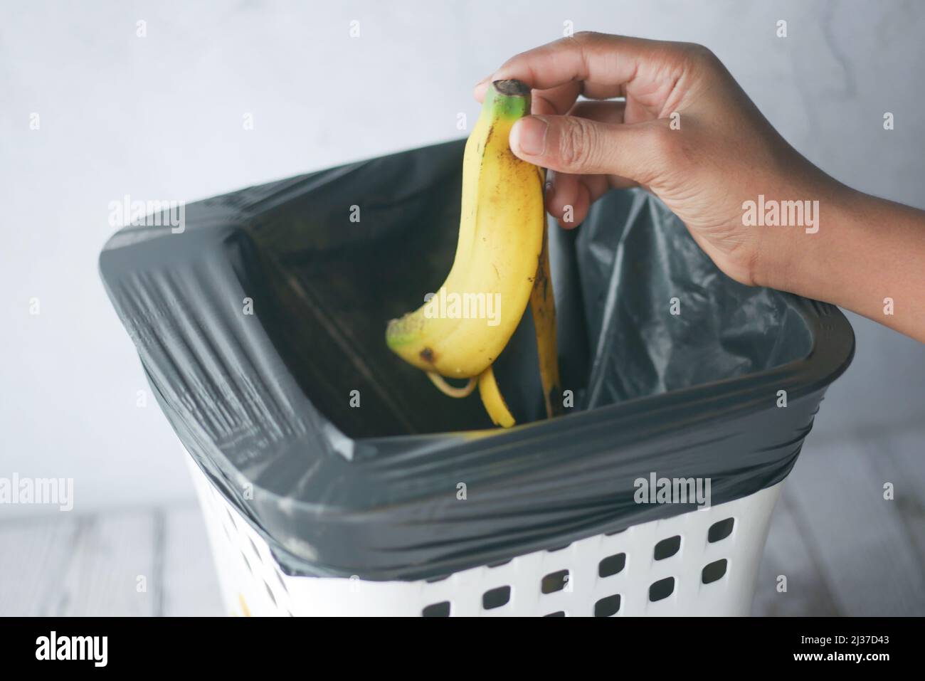 throwing banana in a garbage bin Stock Photo - Alamy