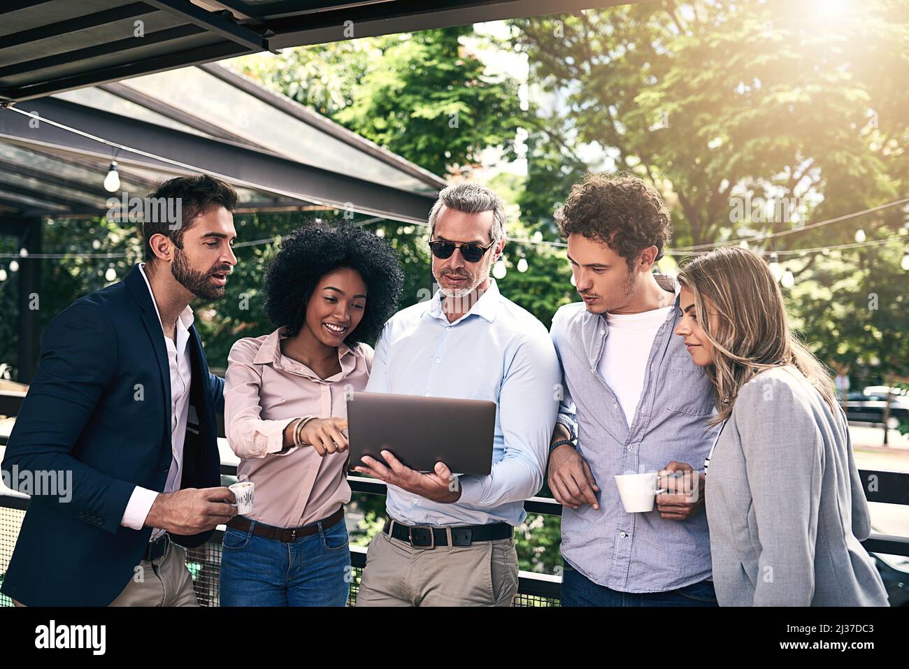 Getting outside for a change. Shot of a group of businesspeople working ...