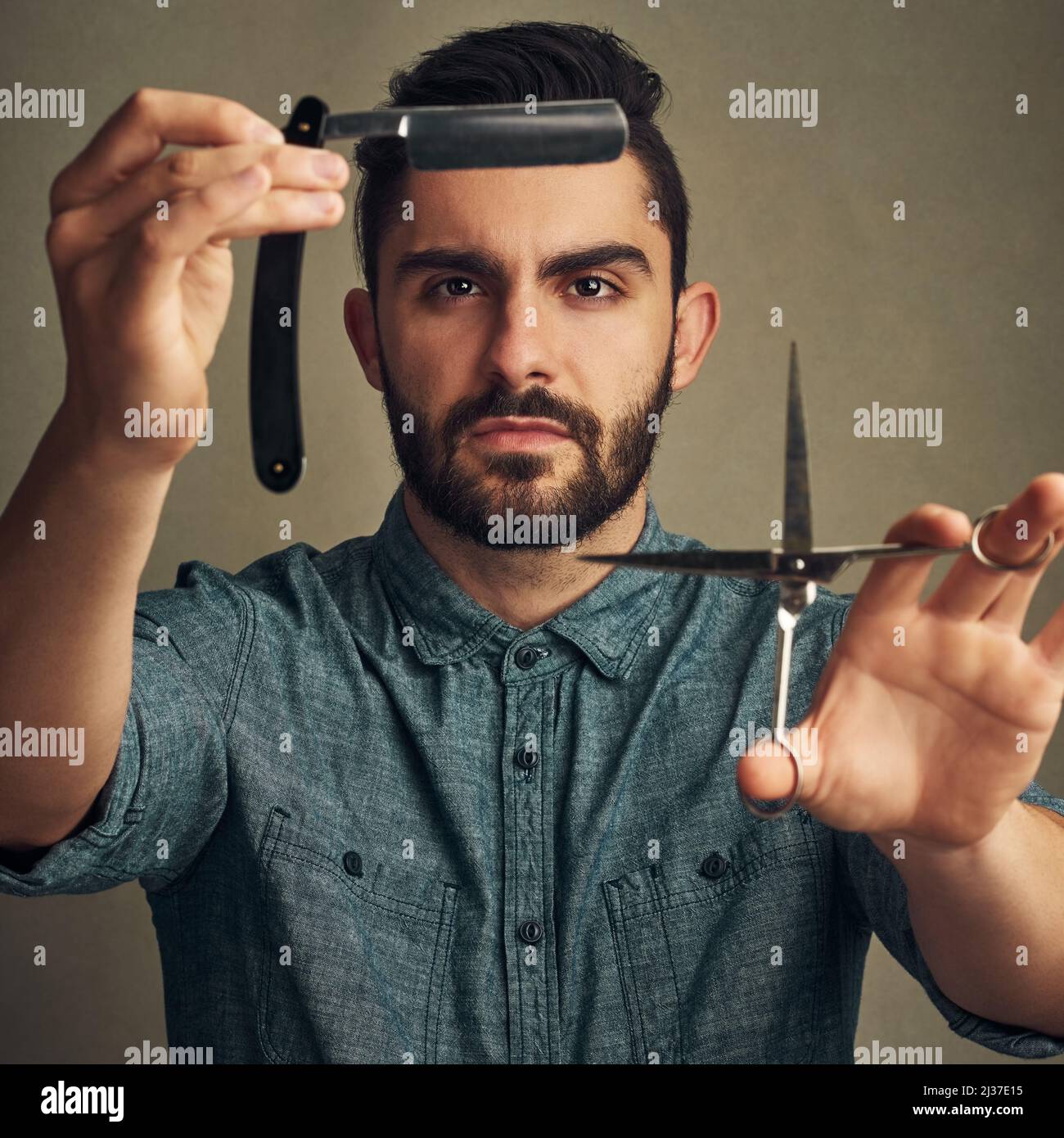 Trim Yes Shave No. Studio shot of a handsome young man holding a ...