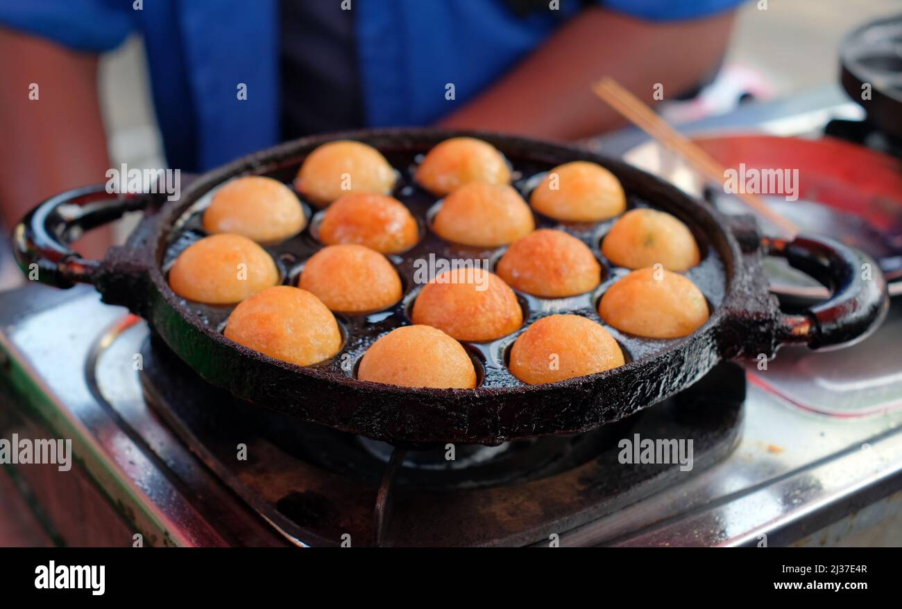Takoyaki is being cooked on a frying pan. Takoyaki making process Stock ...