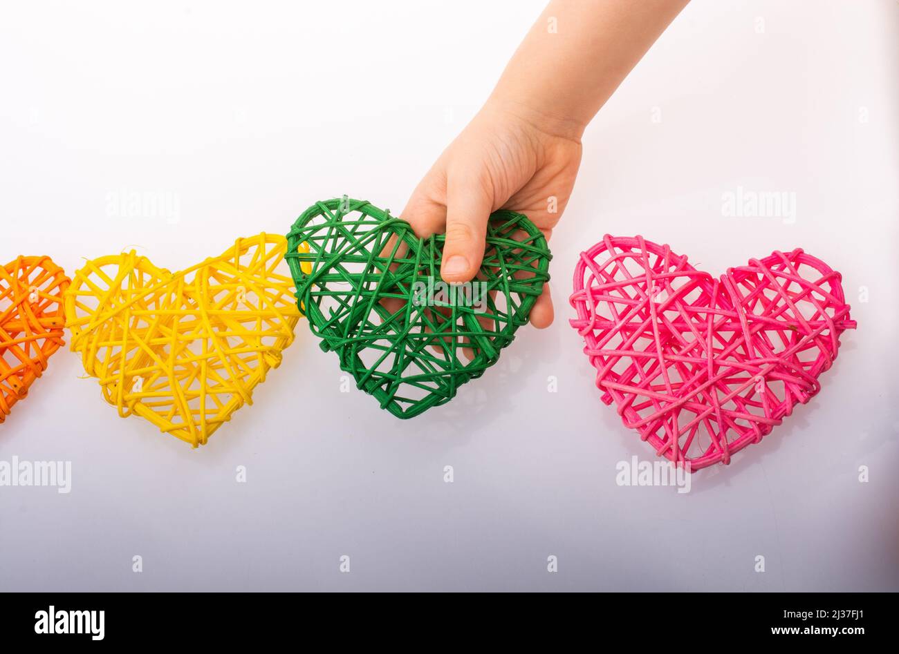 Handmade straw heart or valentines day object in hand Stock Photo - Alamy