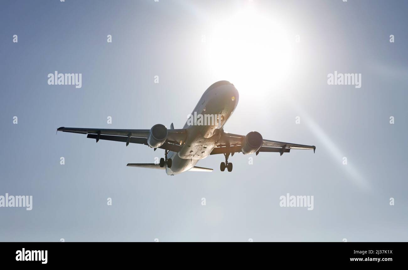 Large airplane preparing the landing with a blue sky Stock Photo - Alamy