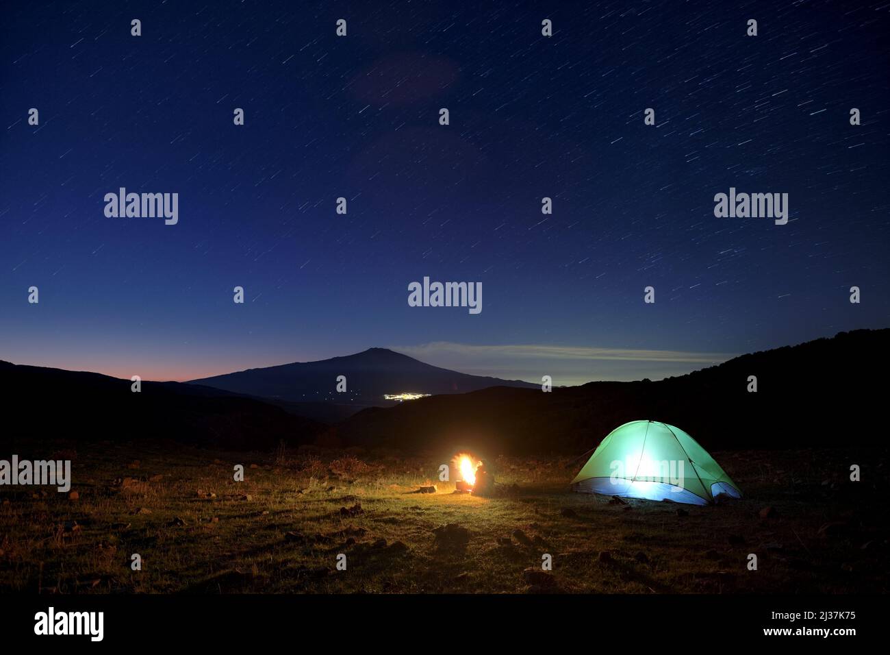lighting tent, campfire and Etna Volcano at dawn from Nebrodi Park ...