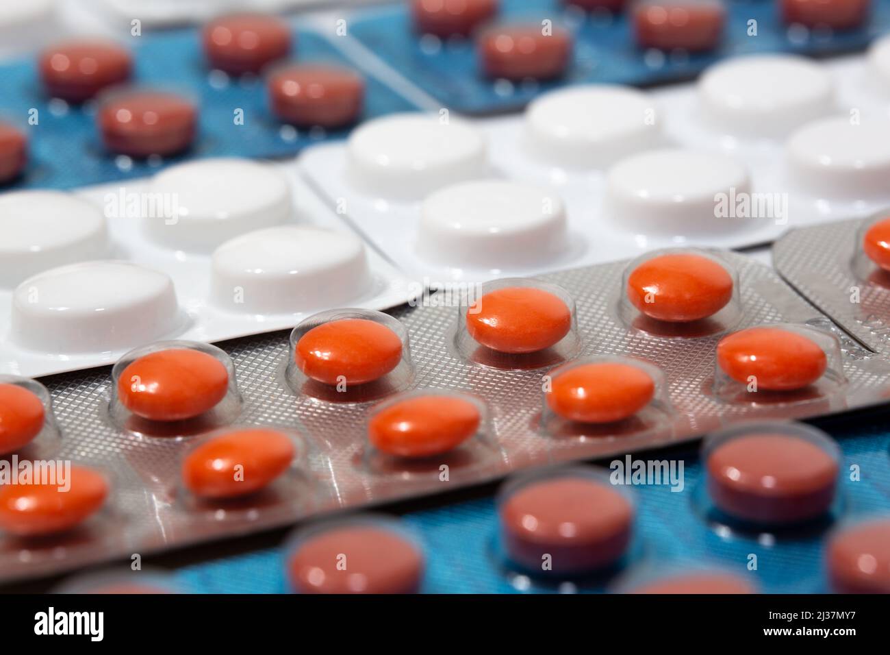 Medicine tablets of different colors are arranged in an orderly manner ...