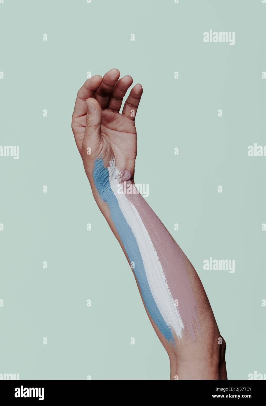 the arm of a young person with the transgender pride flag painted in it ...