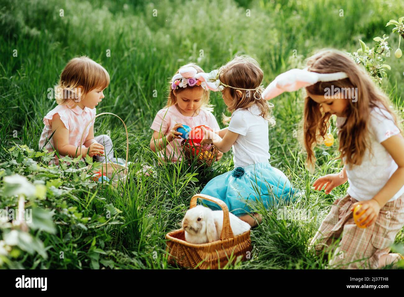 Easter egg hunt. Group Of Children Wearing Bunny Ears Running To Pick ...