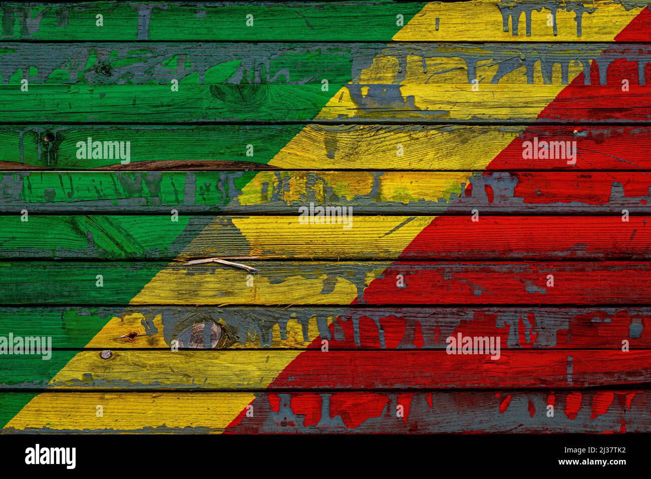 The national flag of Republic of the Congo is painted on uneven boards ...