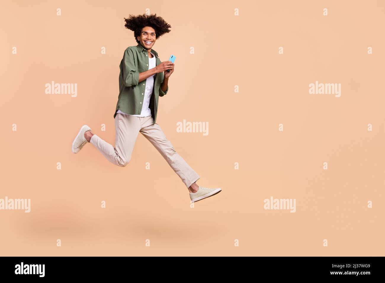 Full length body size view of attractive cheerful trendy guy jumping ...