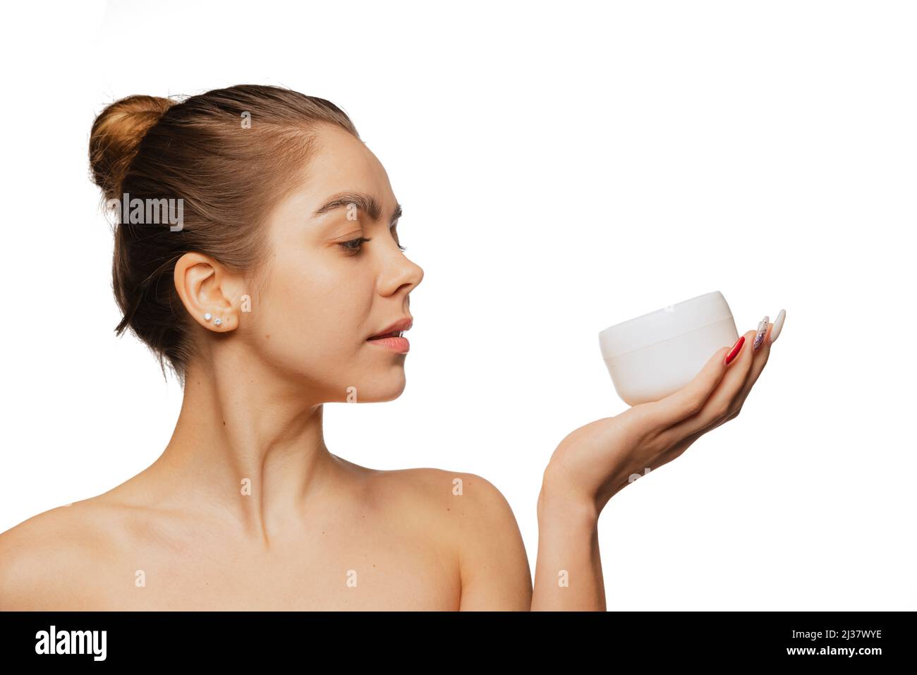 Portrait of beautiful woman with perfect smooth skin with face cream ...
