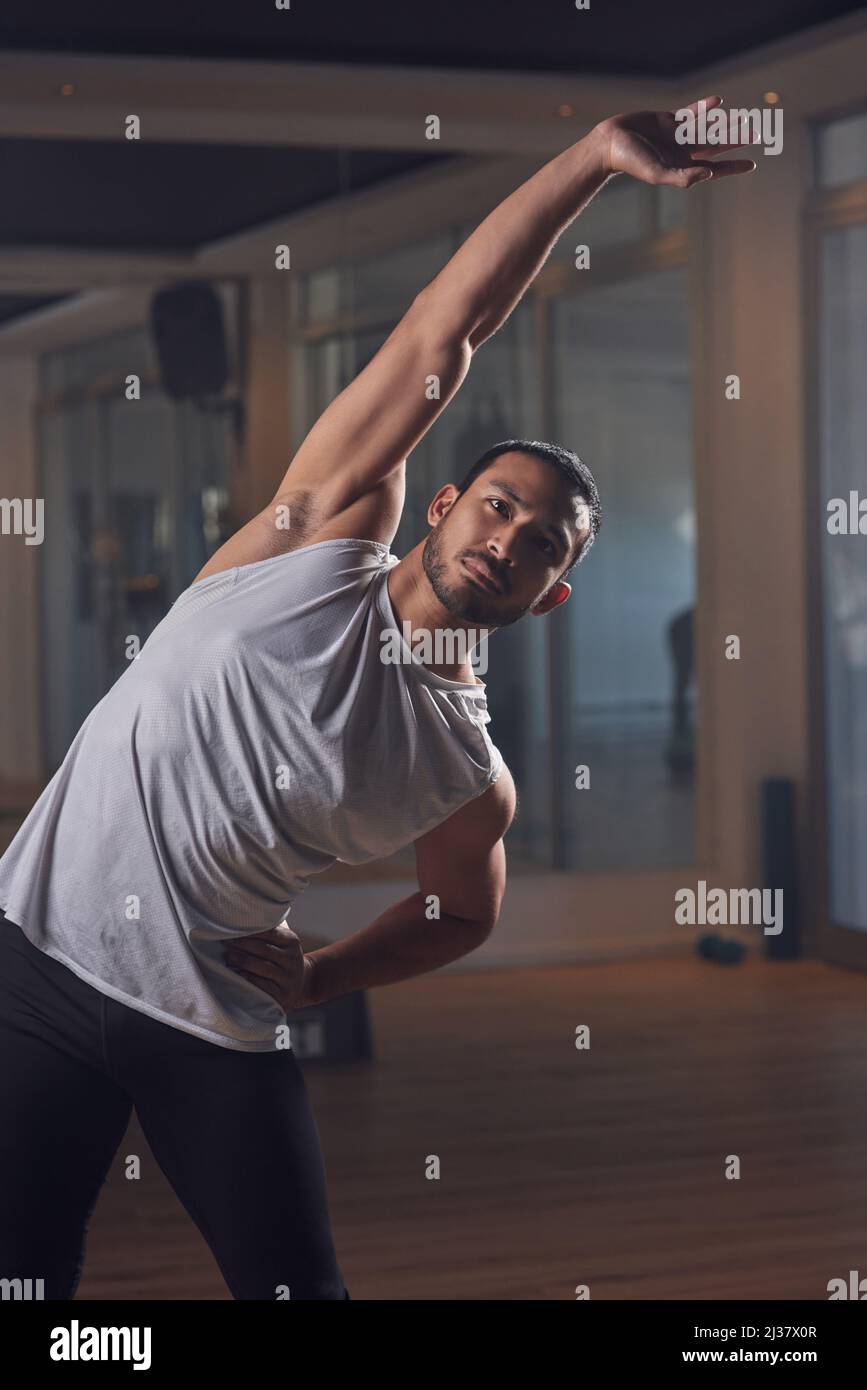 Reaching for his fitness goals. Cropped shot of a handsome young male ...
