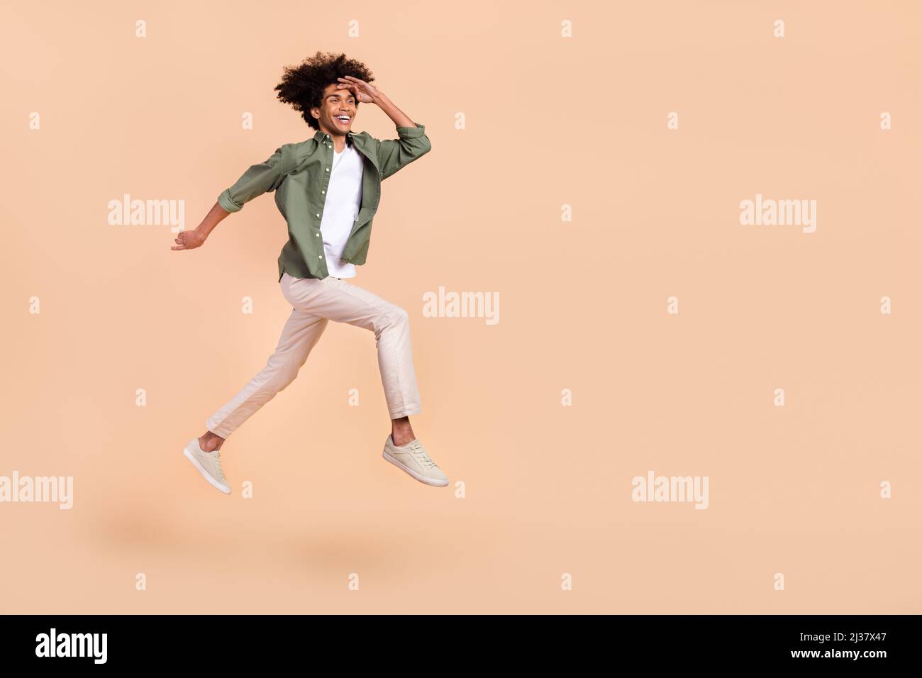 Full length body size view of attractive cheerful guy jumping running ...