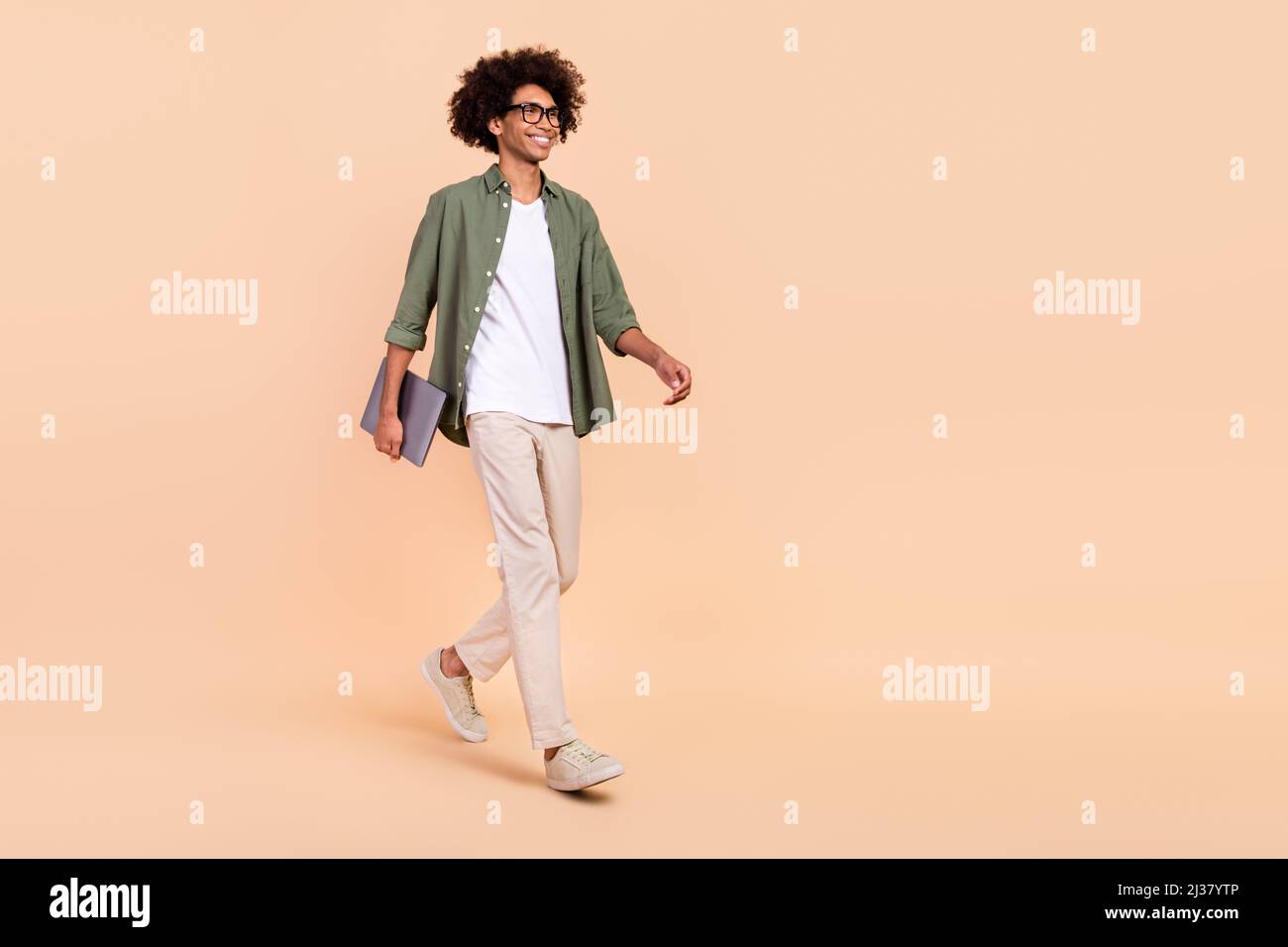 Full size profile photo of cheerful young man hold netbook look empty ...