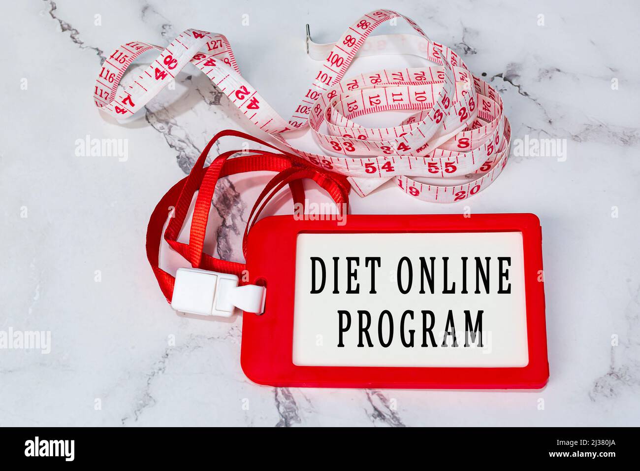 Diet online program text on a red name tag with measure tap on white ...