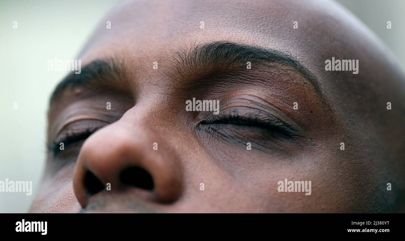 African man closing in meditation and contemplation, close-up black ...