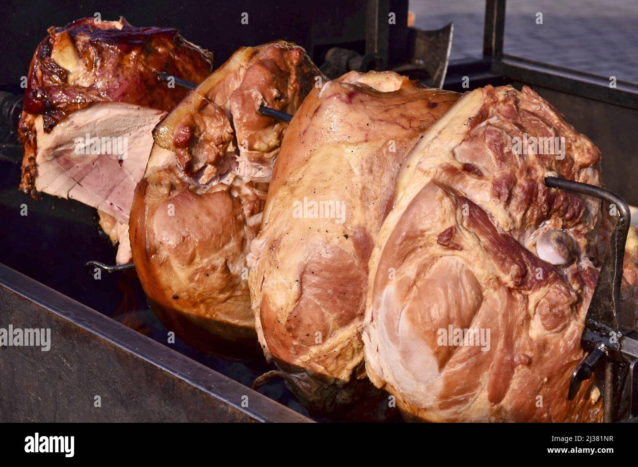 Cured ham roasting on the open fire in Old Town of Prague Czech ...
