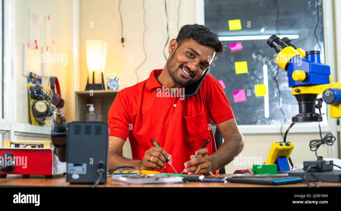 Mobile technician working with talking on mobile phone with customer at ...