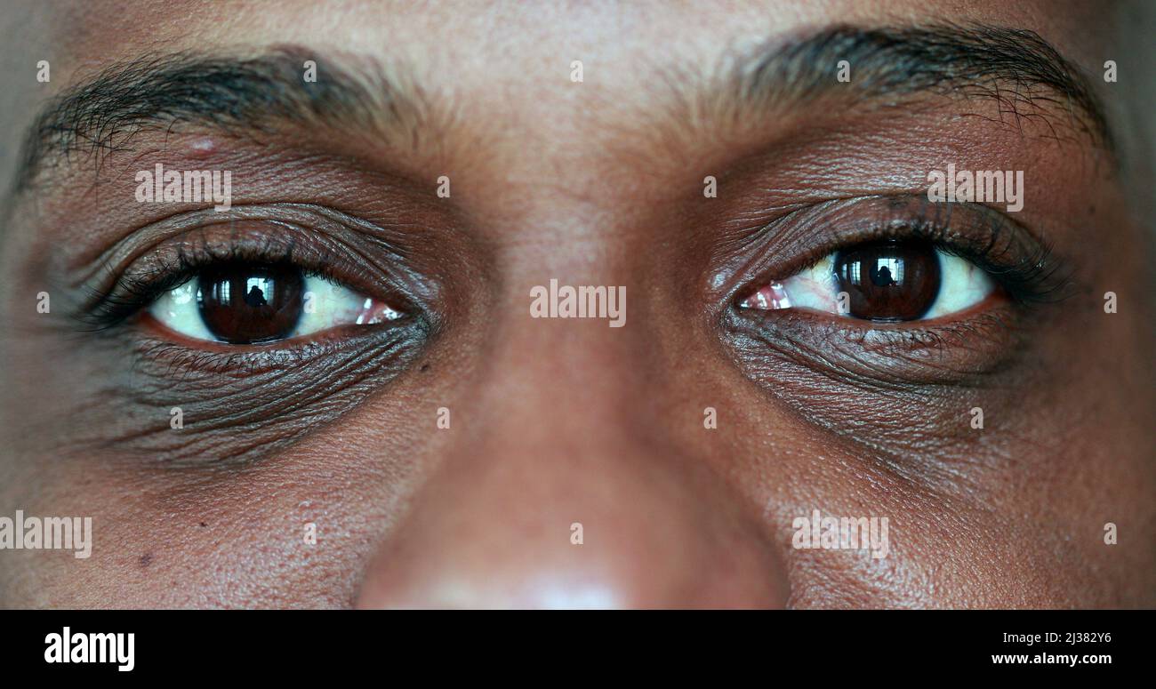 Close-up African American eyes. Man opening eyes and smiling at camera ...