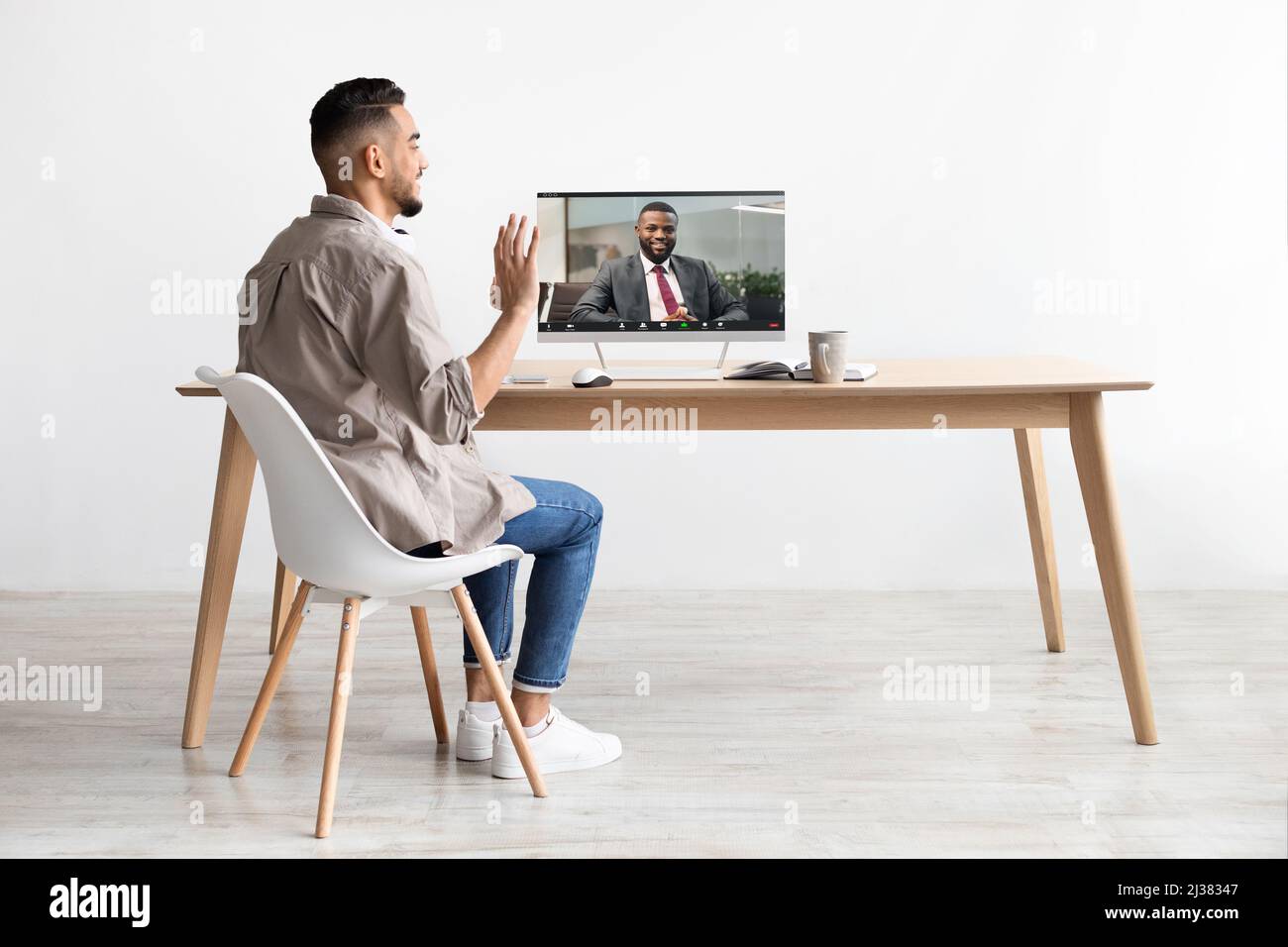 Arab man using laptop waving hand making video call Stock Photo - Alamy