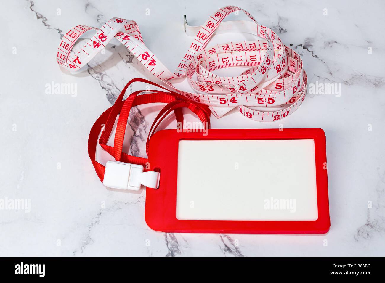 Red name tag with measure tap on white desk. Healthy and diet concept ...