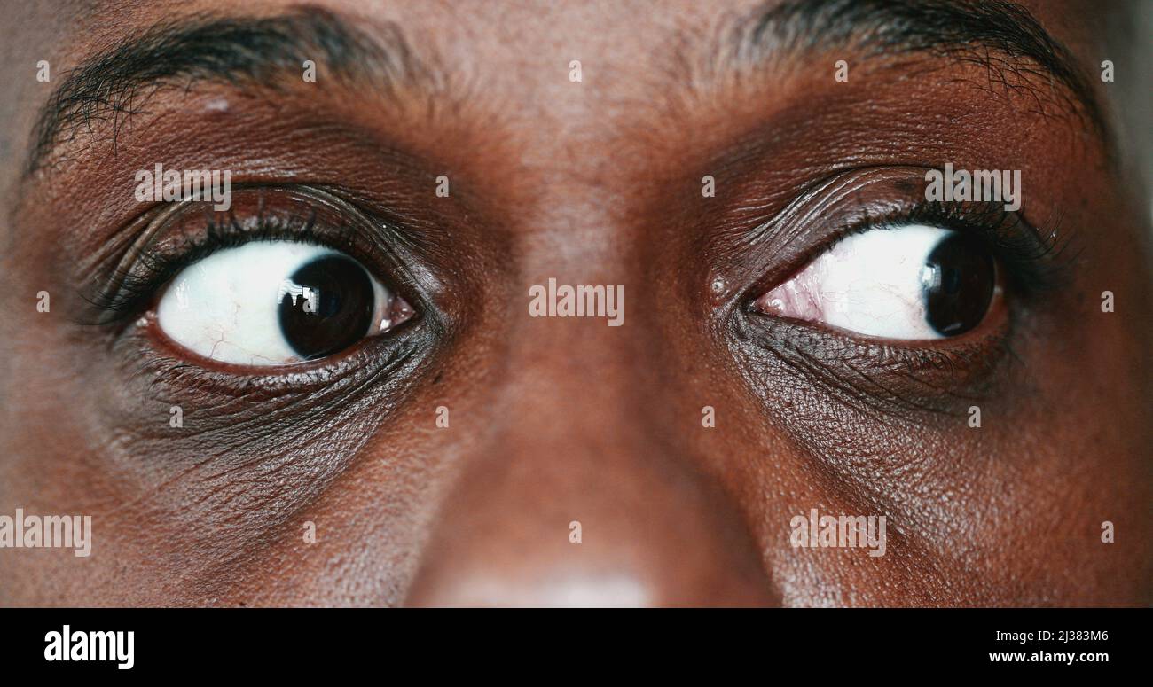 Shocked African man close-up eyes looking in HORROR Stock Photo - Alamy