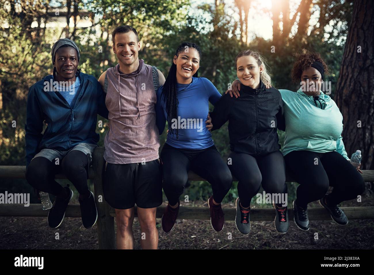 We all friends just trying to get fit. Portrait of a group of sporty ...