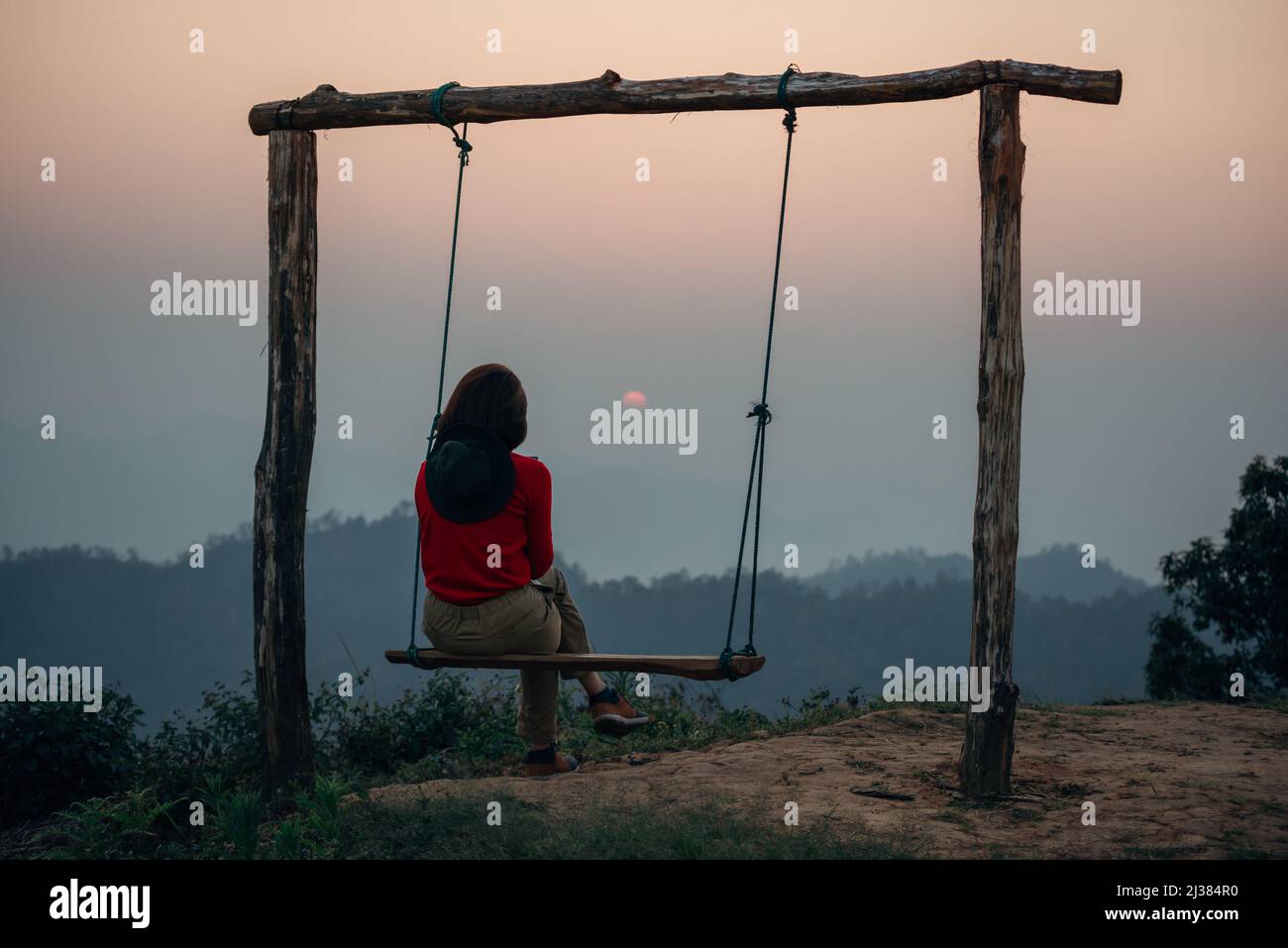 Woman, swing, alone, sky hi-res stock photography and images - Alamy