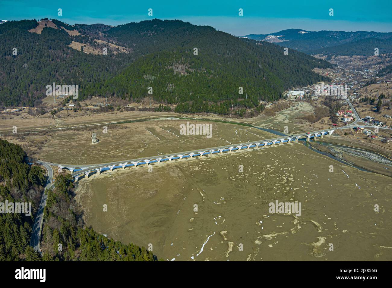 Aerial view at viaduct and dry river on a mountain valley with Piatra ...