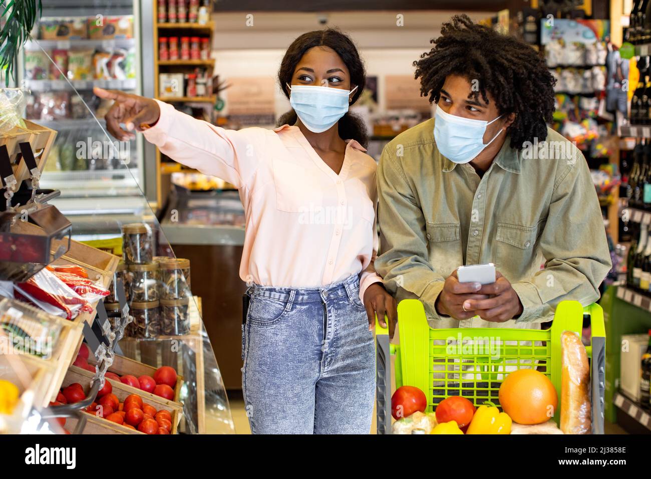 Black Couple Doing Grocery Shopping Wearing Face Masks In Supermarket ...