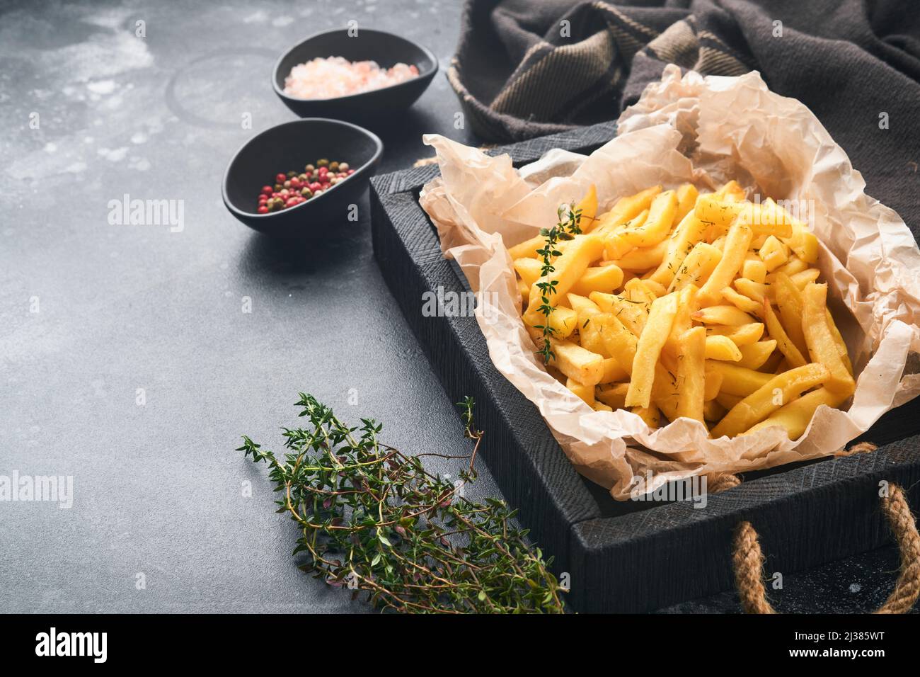 French fries. Tasty French fries server on parchment paper on wooden ...