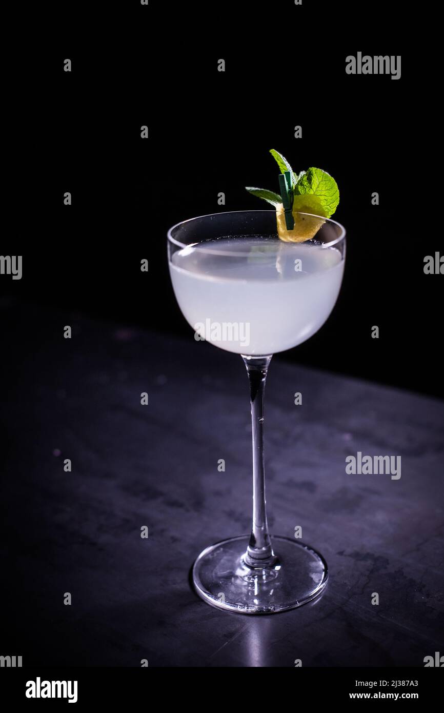 A vertical shot of a classic South Side cocktail with lime and mint on ...