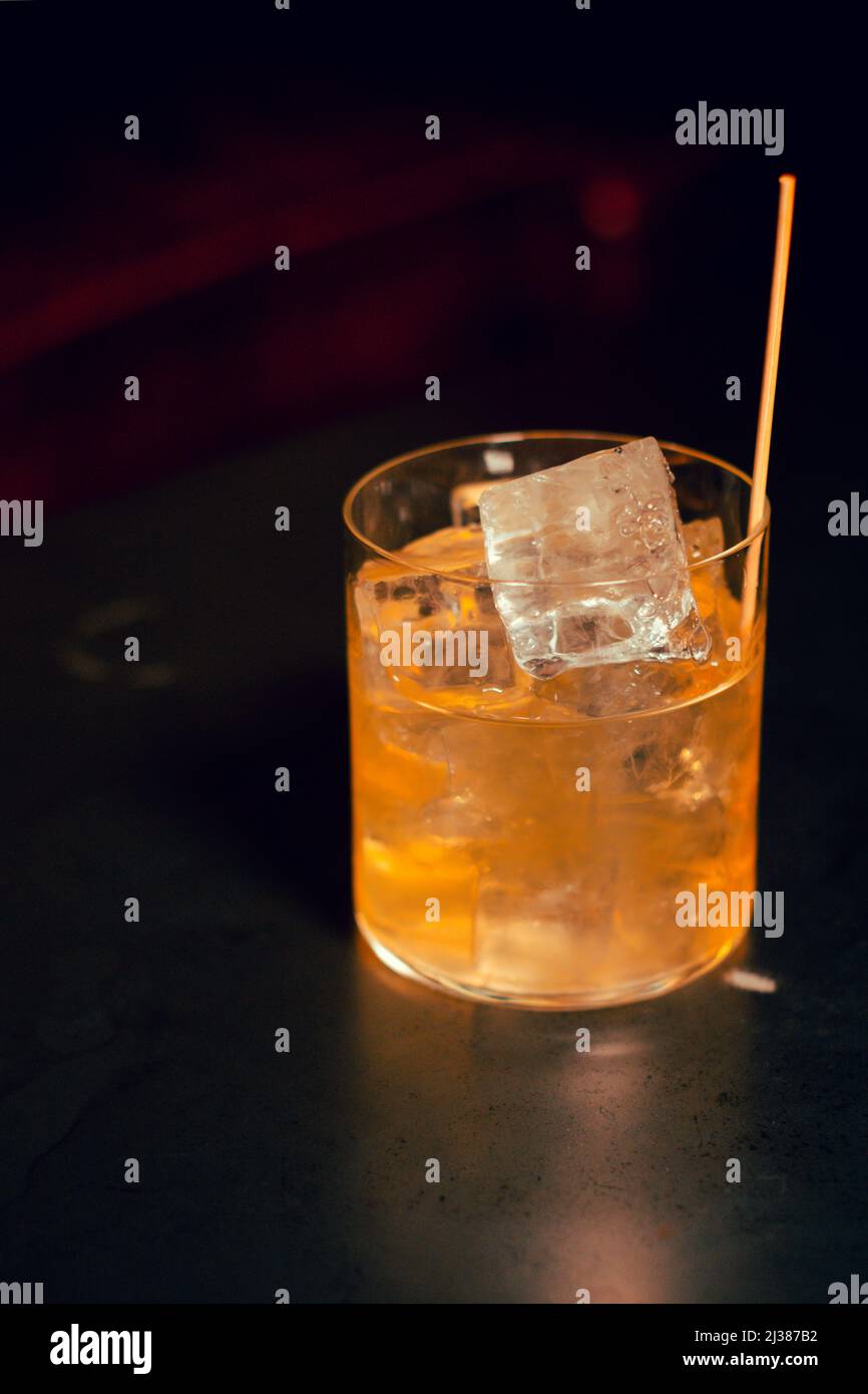 A vertical shot of alcoholic cocktail, bourbon and tonic in a classic ...