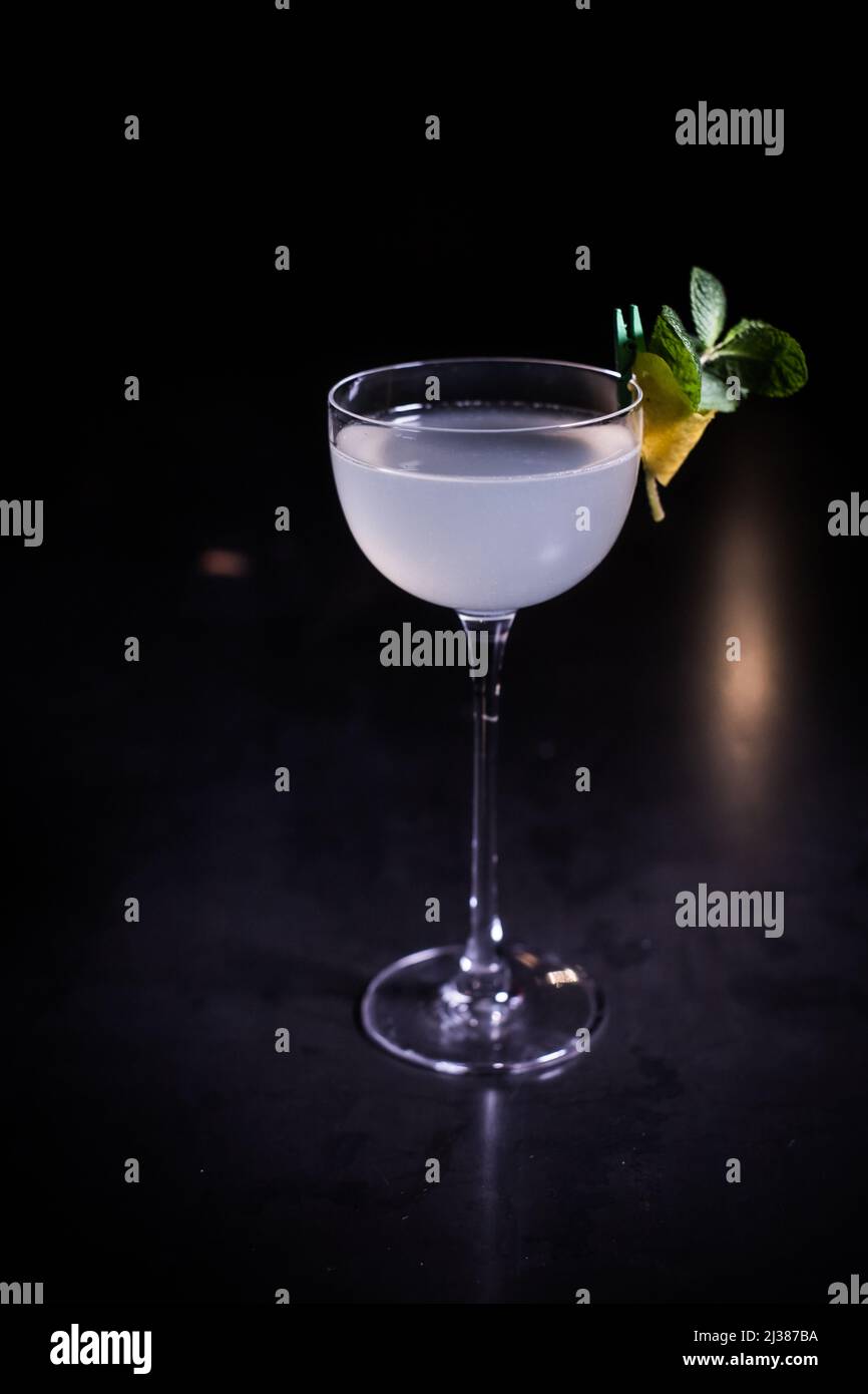 A vertical shot of a classic South Side cocktail with lime and mint on ...