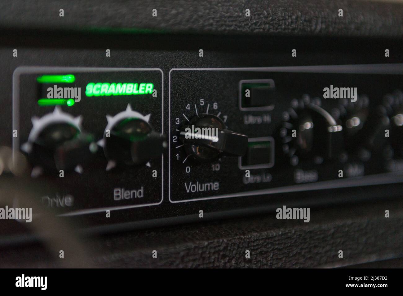 A closeup of a black guitar amplifier box with buttons and knobs on it ...