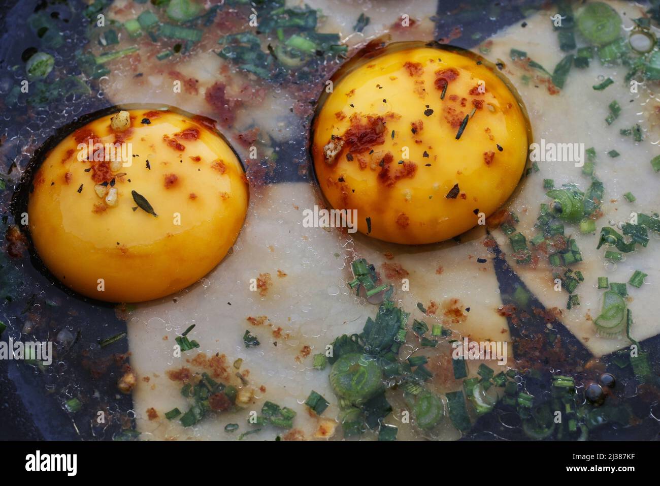 Consecutive steps of preparing fried eggs with ham and herbs. Step by ...
