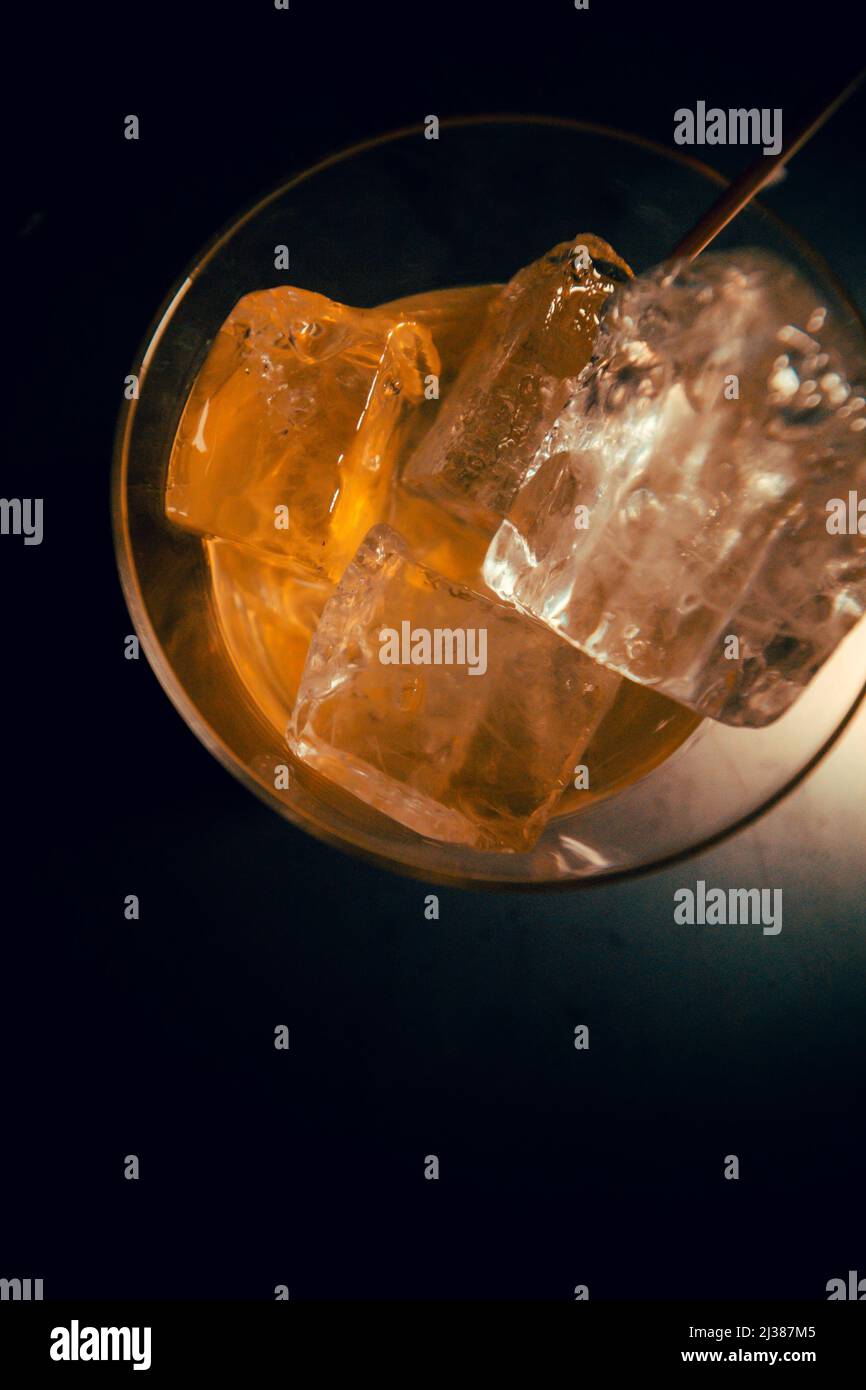 A top view of alcoholic cocktail, bourbon and tonic in a classic glass ...