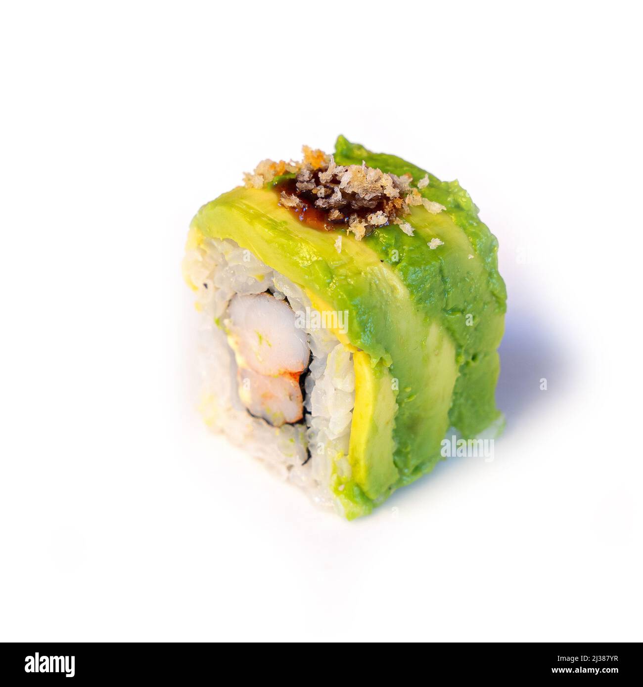 A closeup of a sushi roll with shrimp, and avocado topping isolated on ...