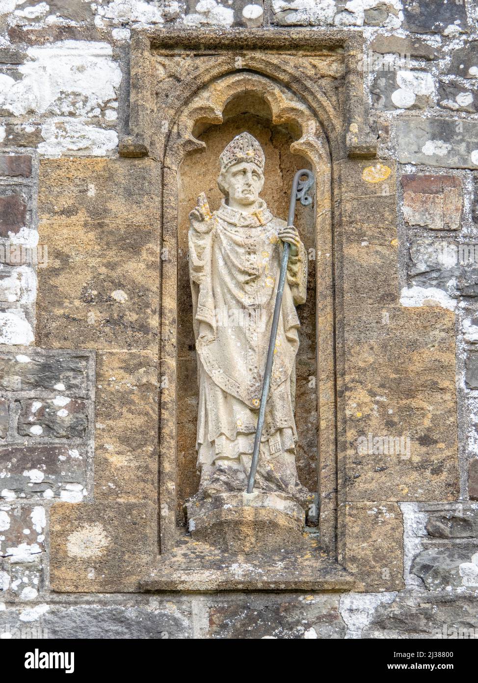 LITTLEHAM VILLAGE, DEVON, ENGLAND- MARCH 26 2022: Ancient statue of St ...